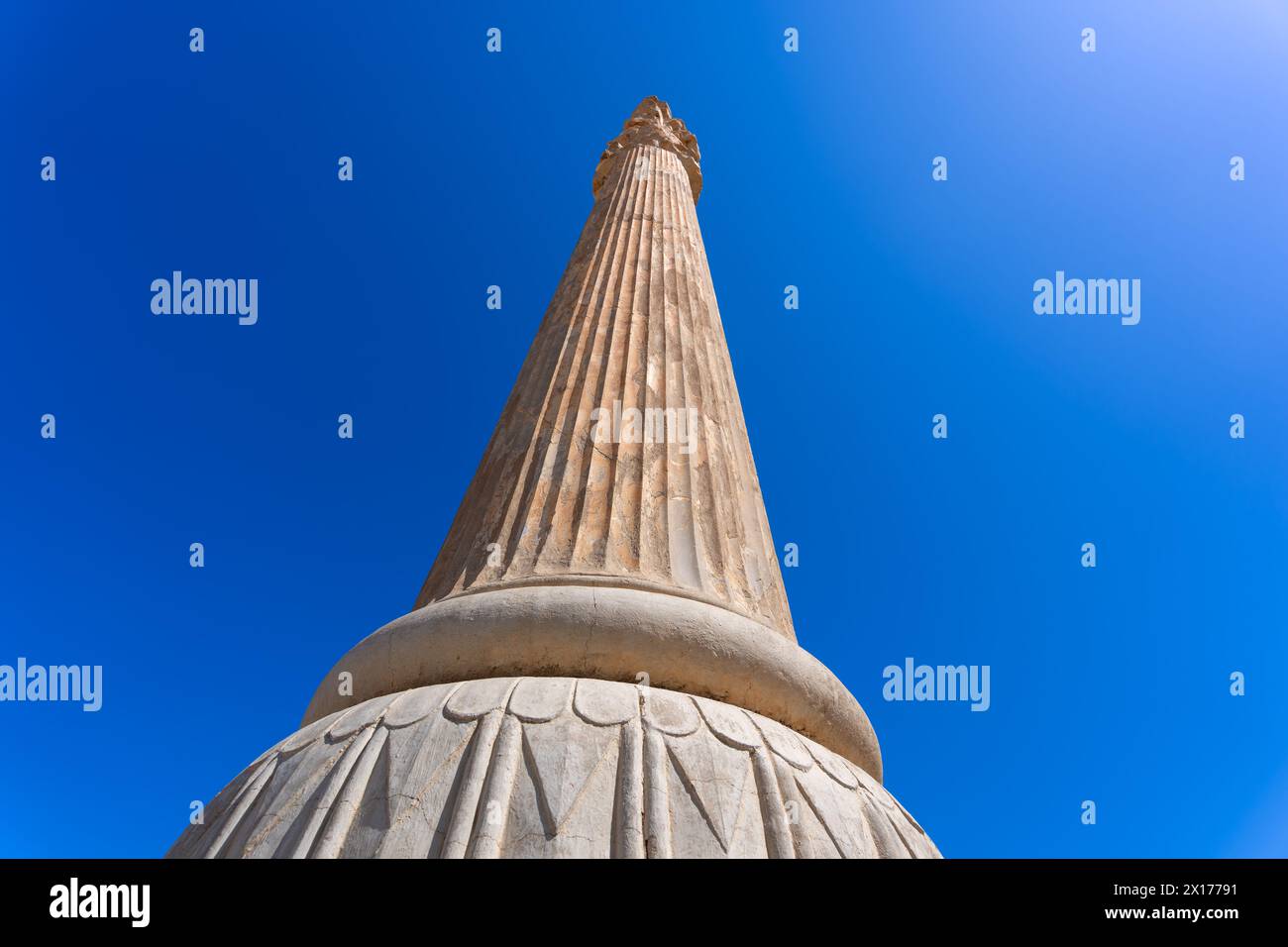 A towering column adorned with intricate carvings stands against the ...