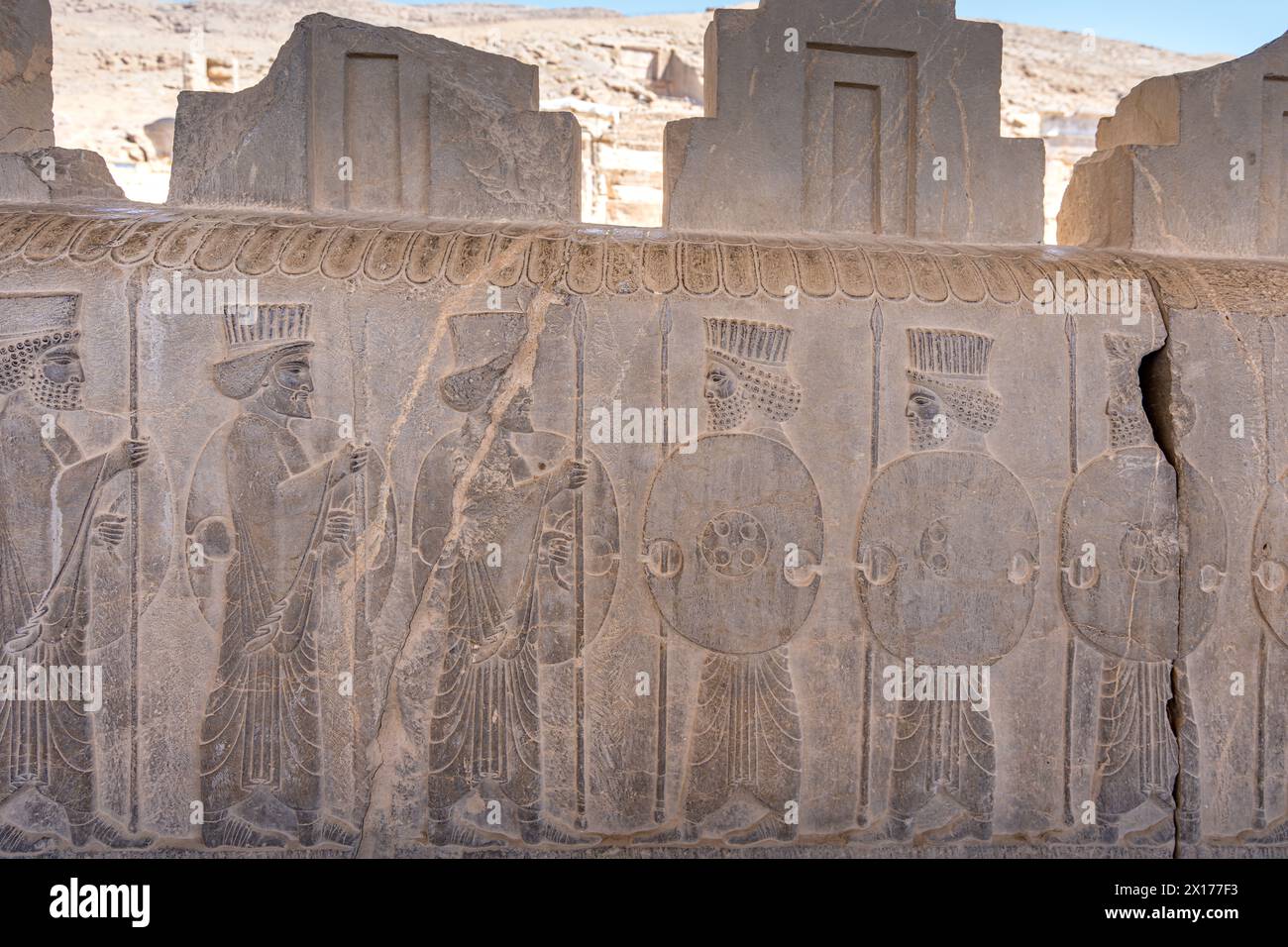 Detailed stone engravings depicting people and animals in motion. A ...