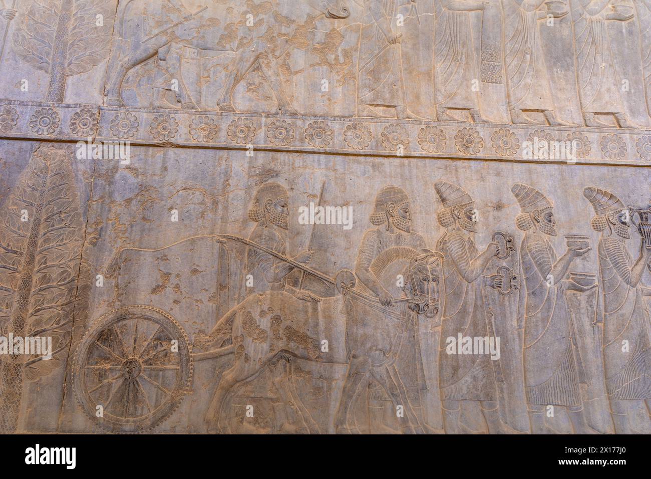 Detailed stone engravings depicting people and animals in motion. A ...