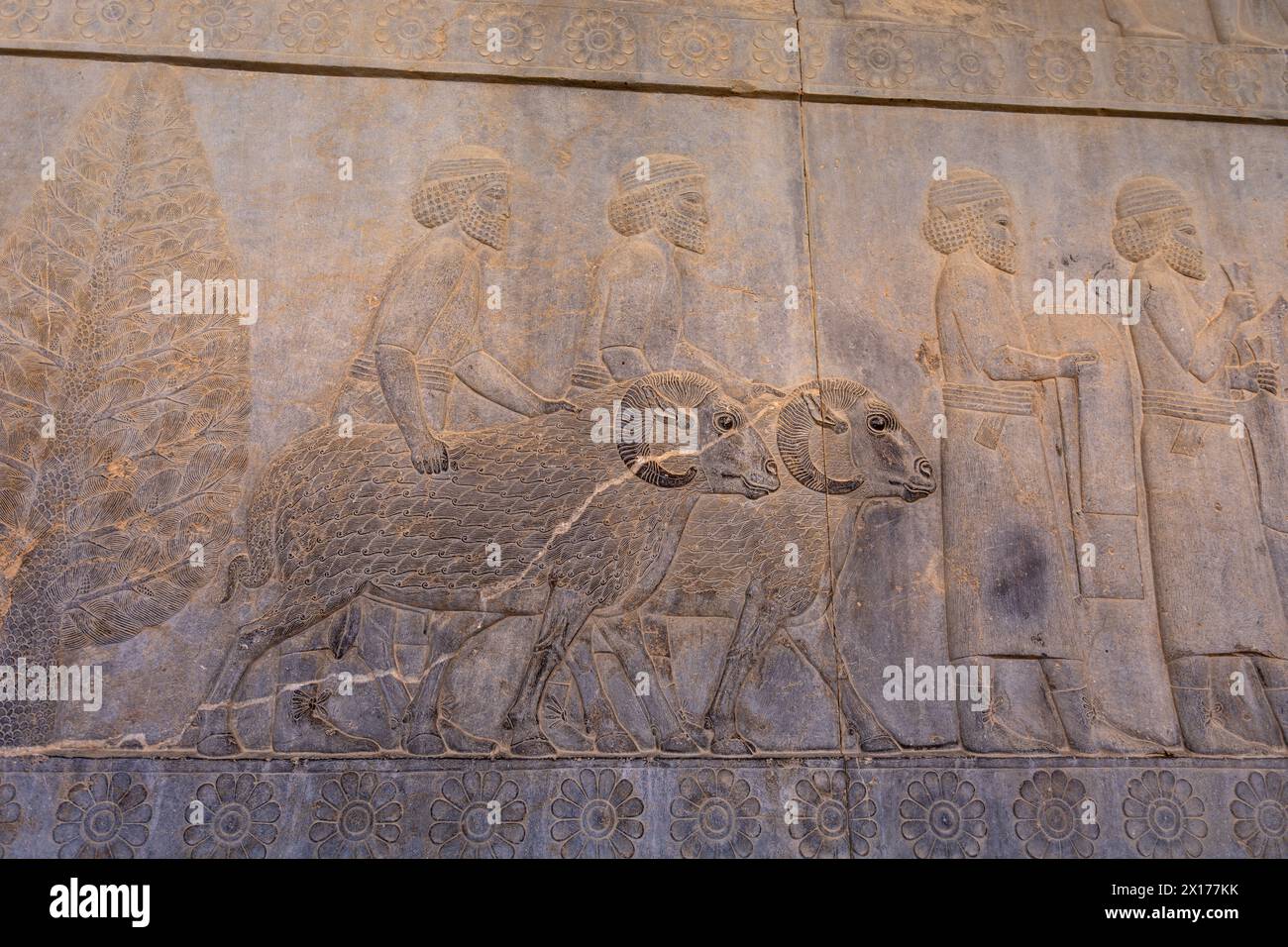 Detailed stone engravings depicting people and animals in motion. A ...