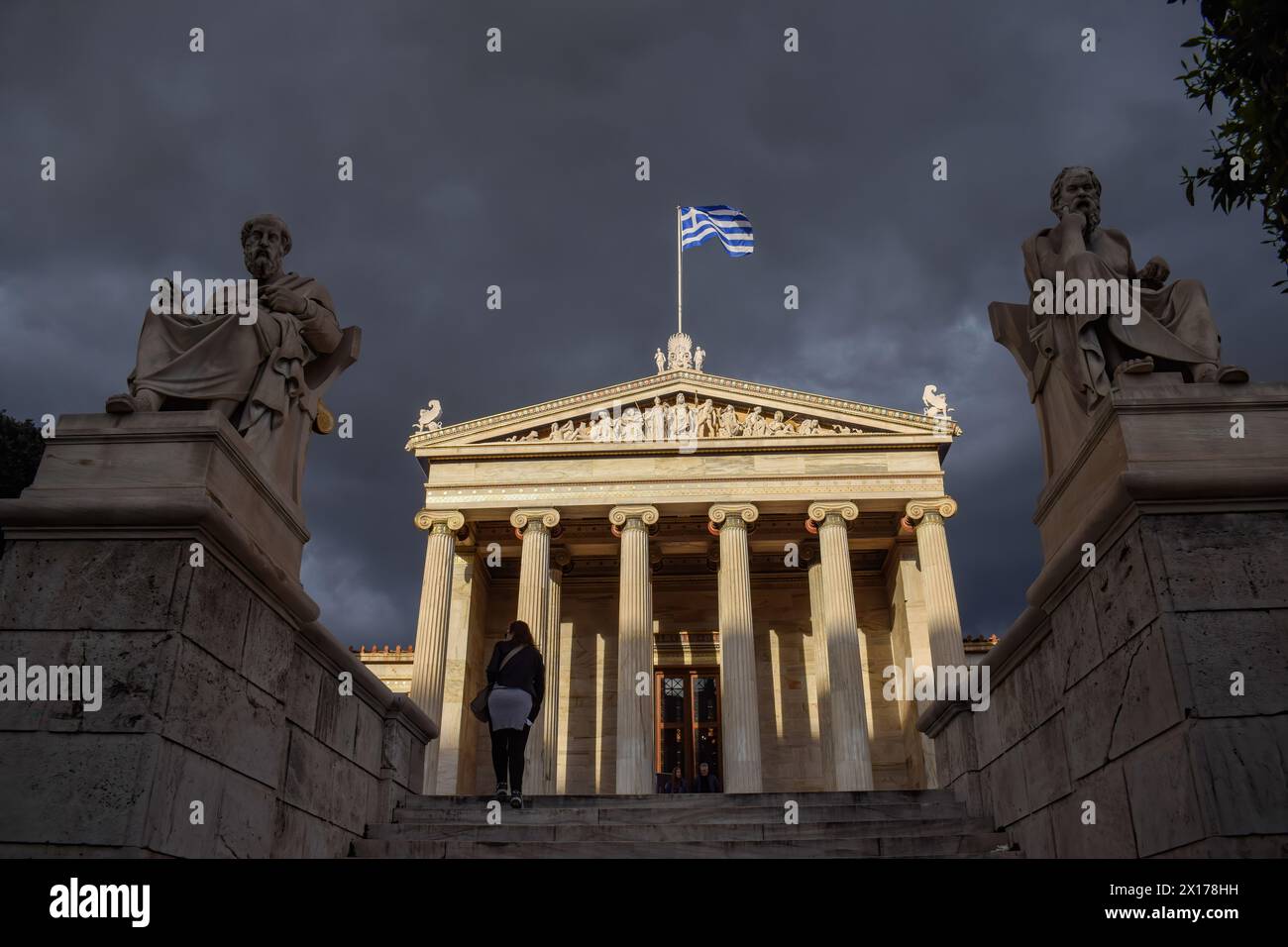 Athens, Greece: People walk ahead of the neoclassical building of the ...
