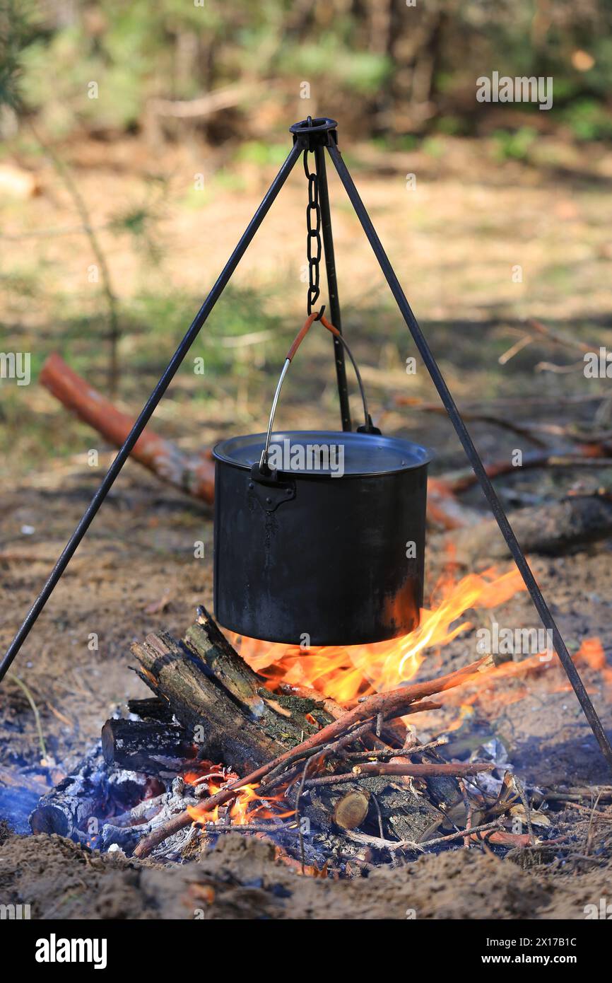 smoked tourist kettle over fire in forest Stock Photo - Alamy