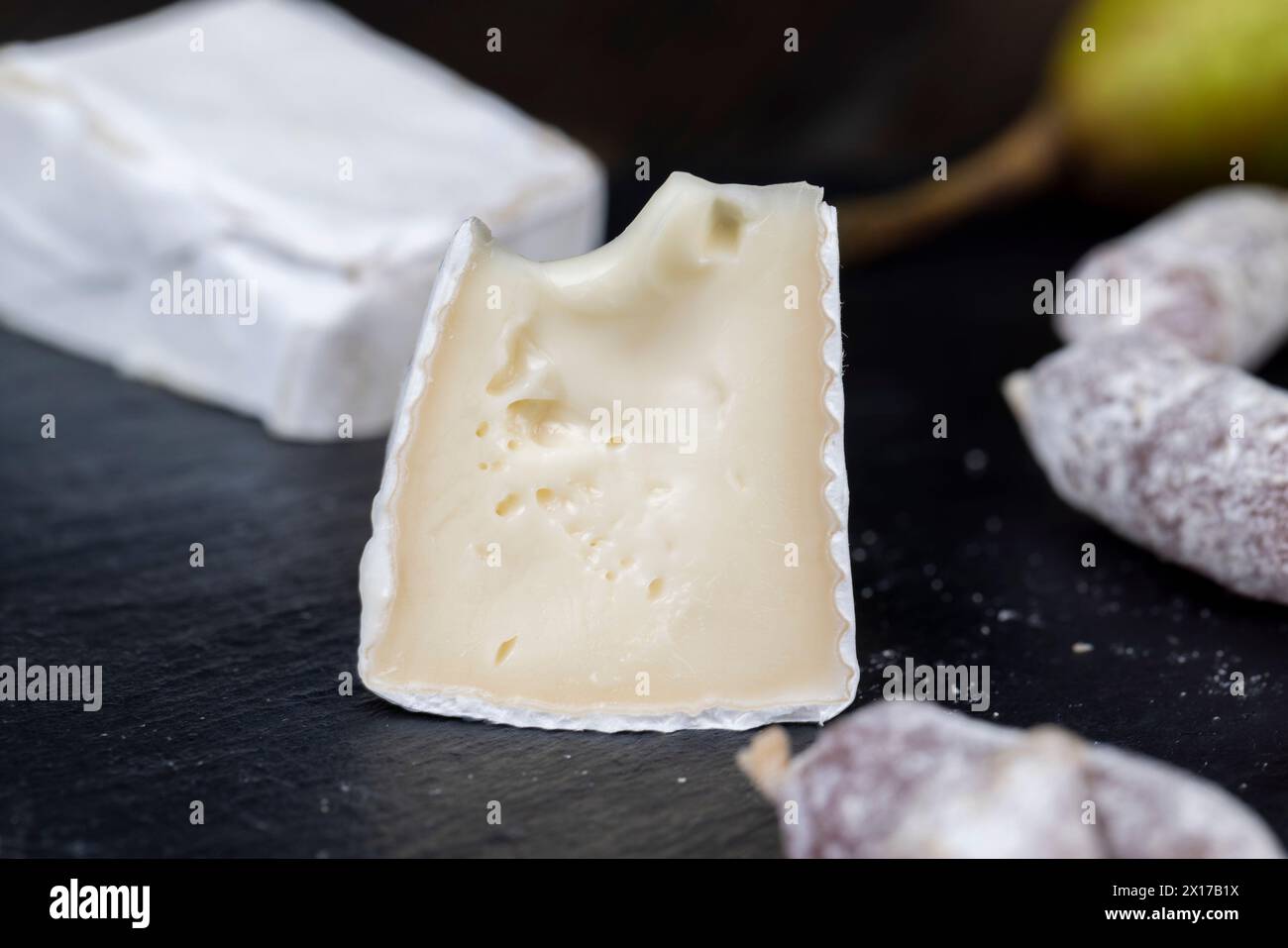 soft cheese with white mold close-up, pieces of cream cheese with white ...