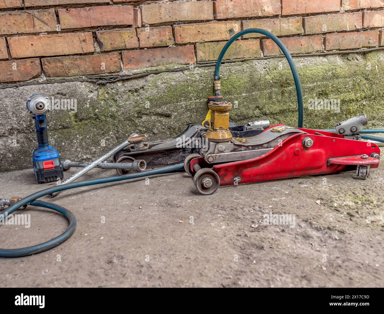 Hydraulic jack and air impact wrench ready for tire change Stock Photo ...