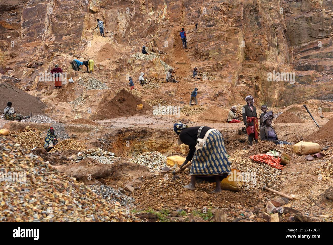 A group of men, women and children, one of them sticking out his tongue ...
