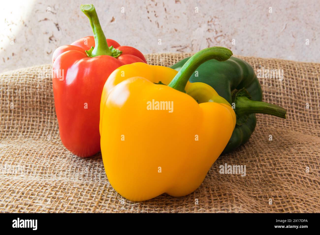 Three sweet paprika on the natural background. Red, yellow, green fresh ...