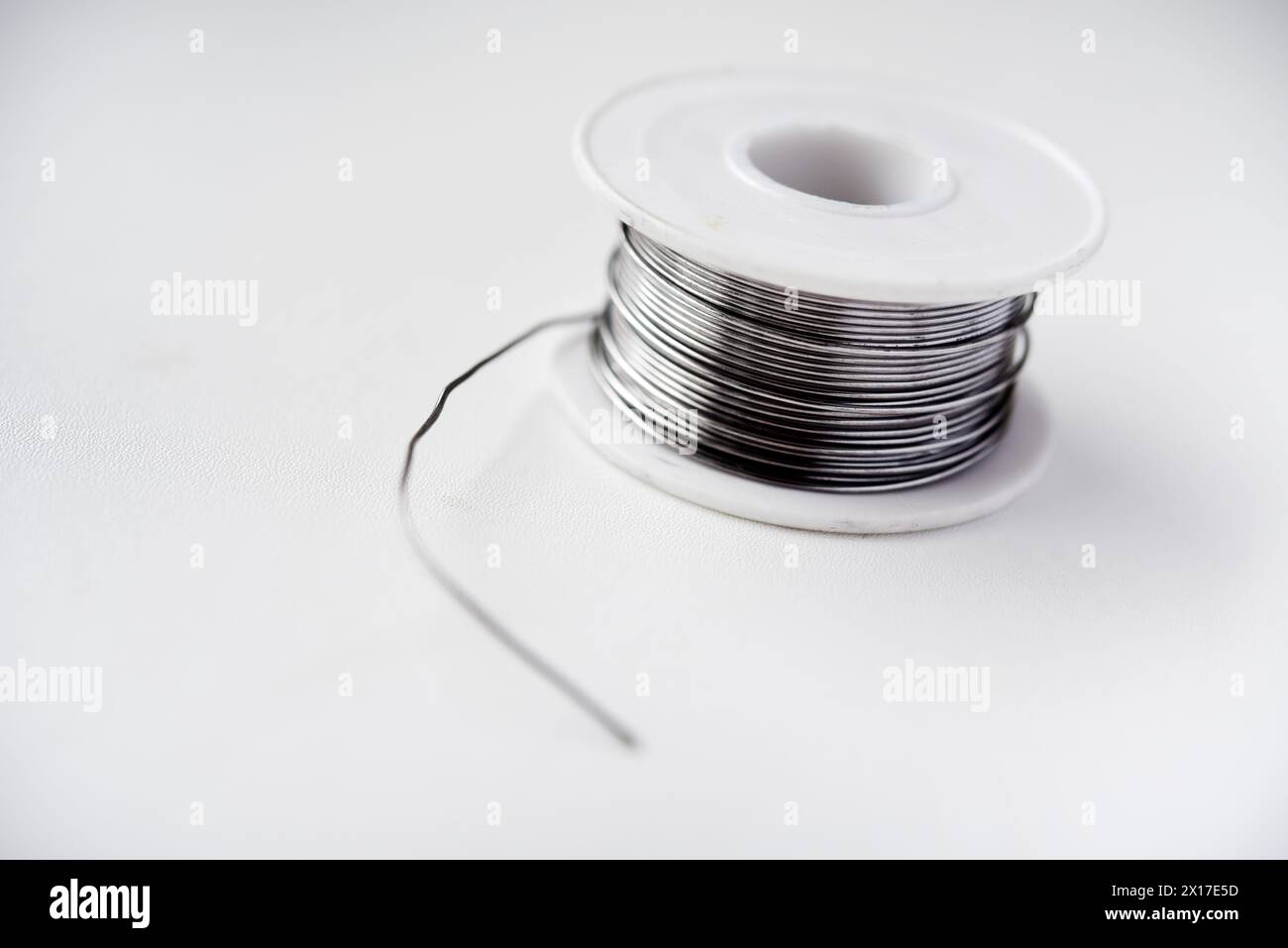 Tin-lead solder in coils on a white background. Materials for soldering ...
