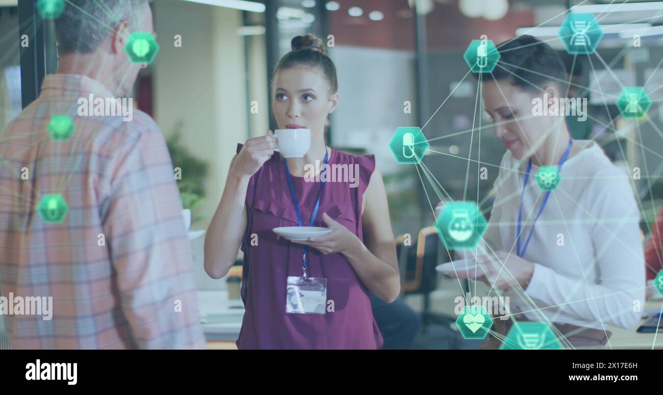 Image of globes of digital icons over group of diverse colleagues ...