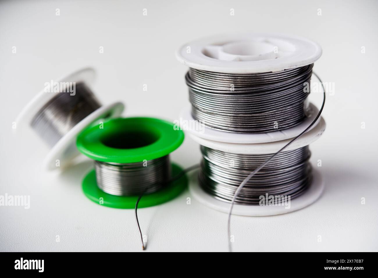 Tin-lead solder in coils on a white background. Materials for soldering ...