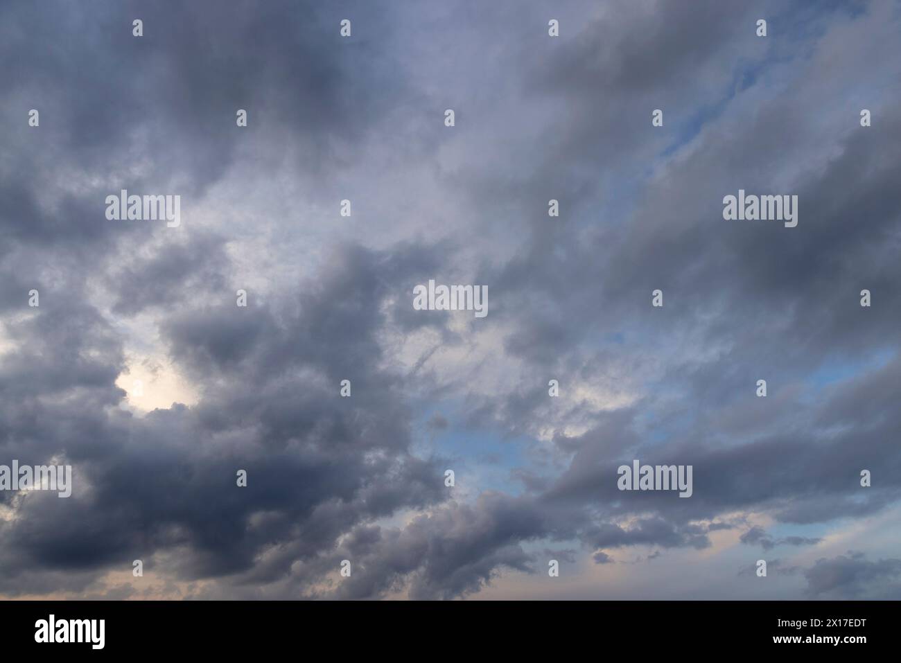 a darkening sky with clouds at sunset, a beautiful sky with slowly ...