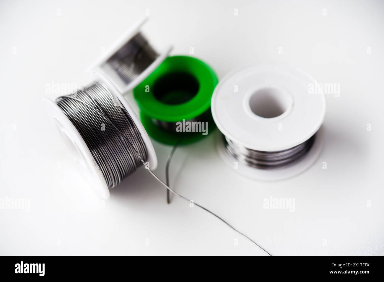 Tin-lead solder in coils on a white background. Materials for soldering ...
