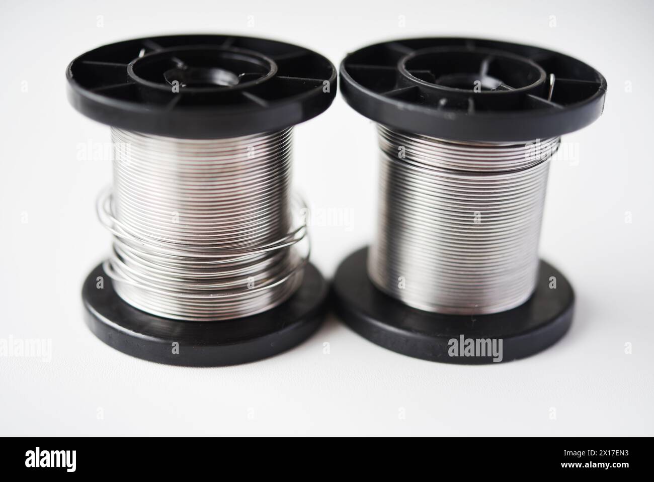 Tin-lead solder in coils on a white background. Materials for soldering ...