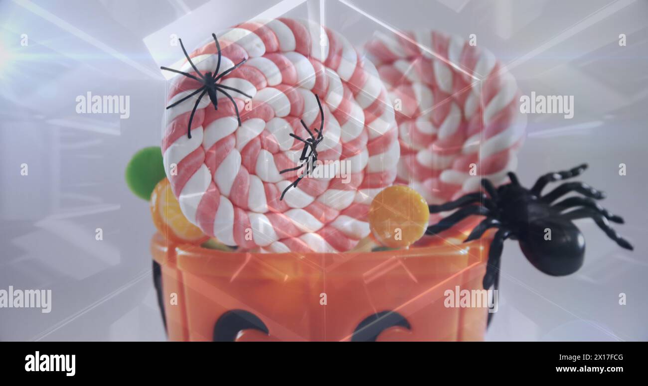 Glowing tunnel against spiders and candies in halloween pumpkin bucket ...