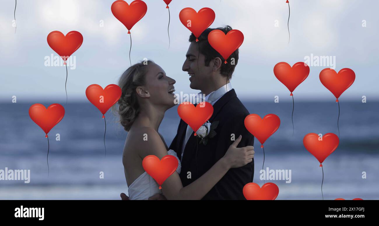 Image of multiple red heart balloons floating over newly married couple ...