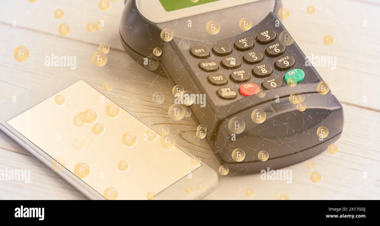 Image of bitcoins over and payment terminal Stock Photo - Alamy