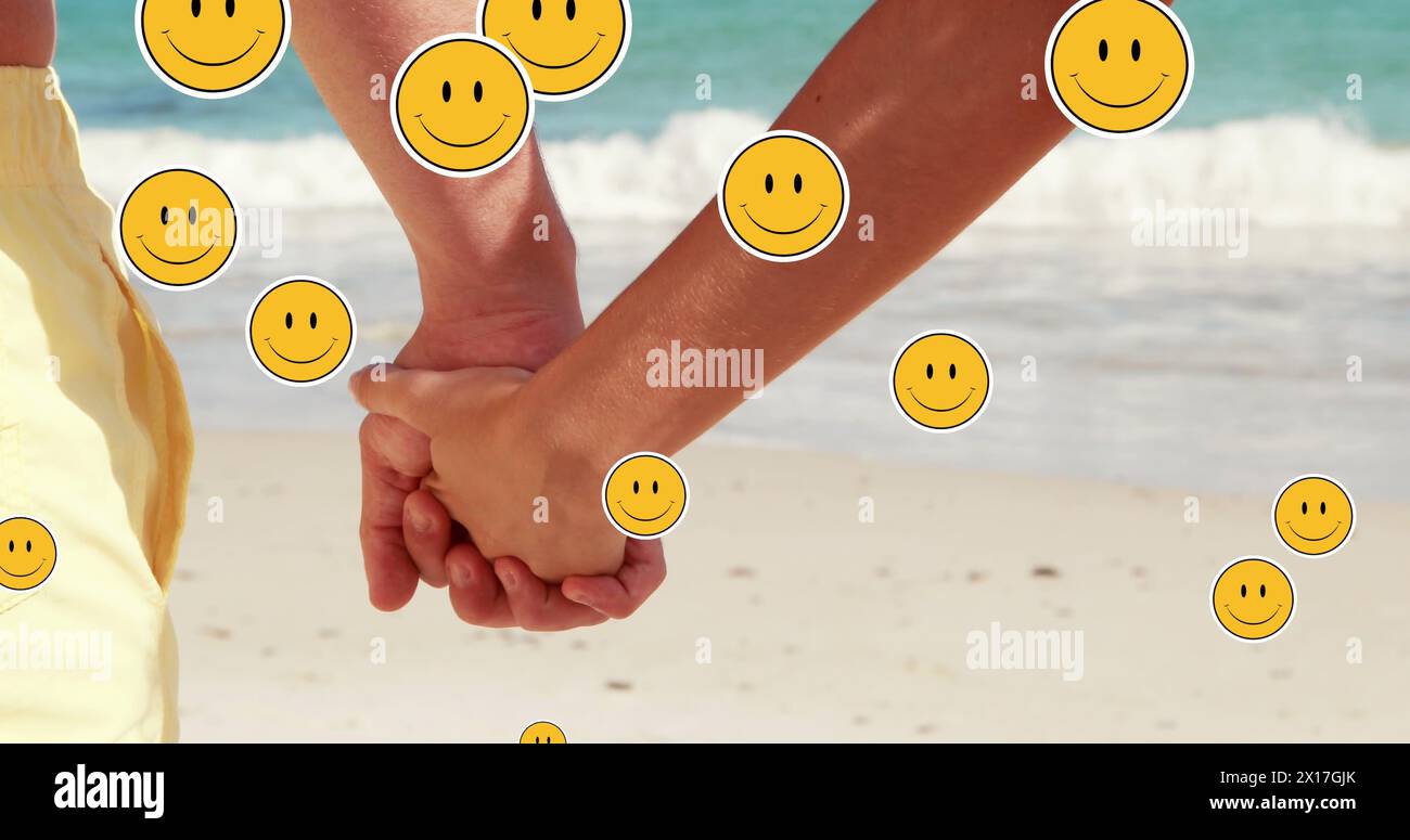 Image of multiple smiling face emoji floating against mid section of ...