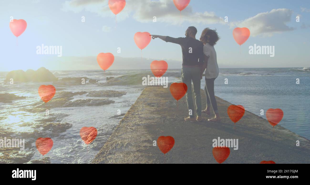 Image of red heart floating over couple in love holding hands by ...
