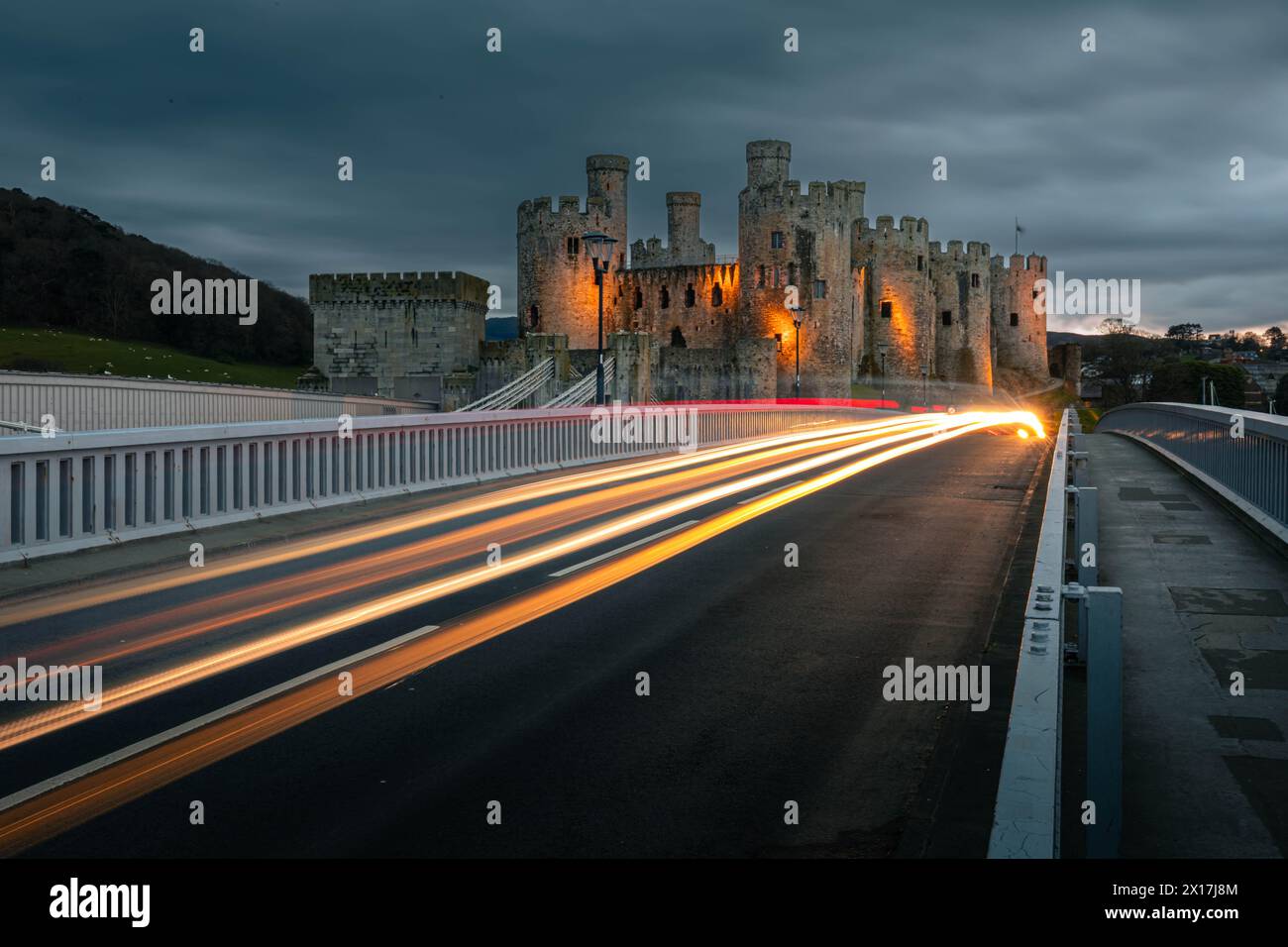 Conway Castle (Castell Conwy) North Wales, with car lights moving ...