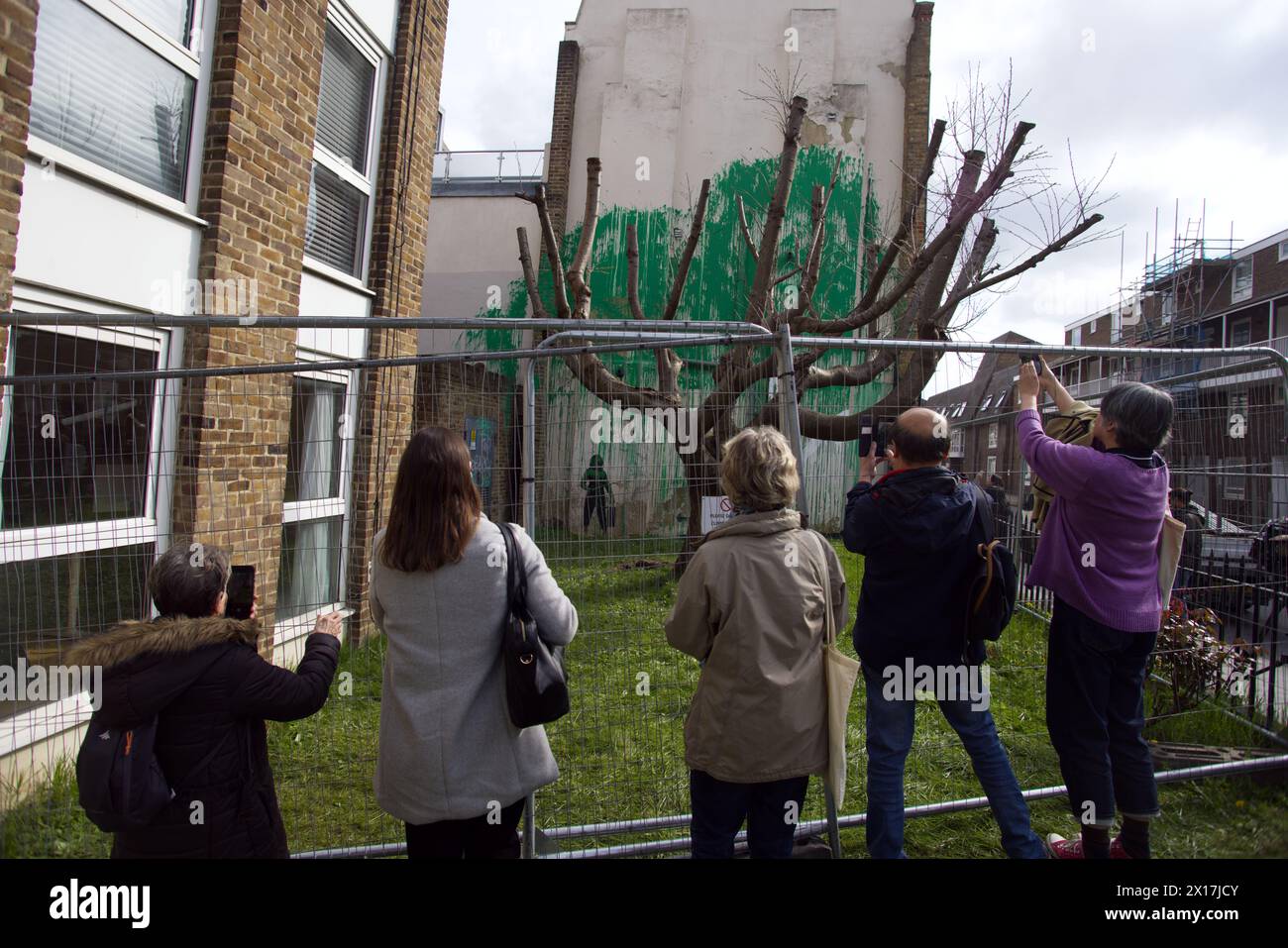 Fenced off, Banksy tree mural, Hornsey Road, North London Stock Photo ...