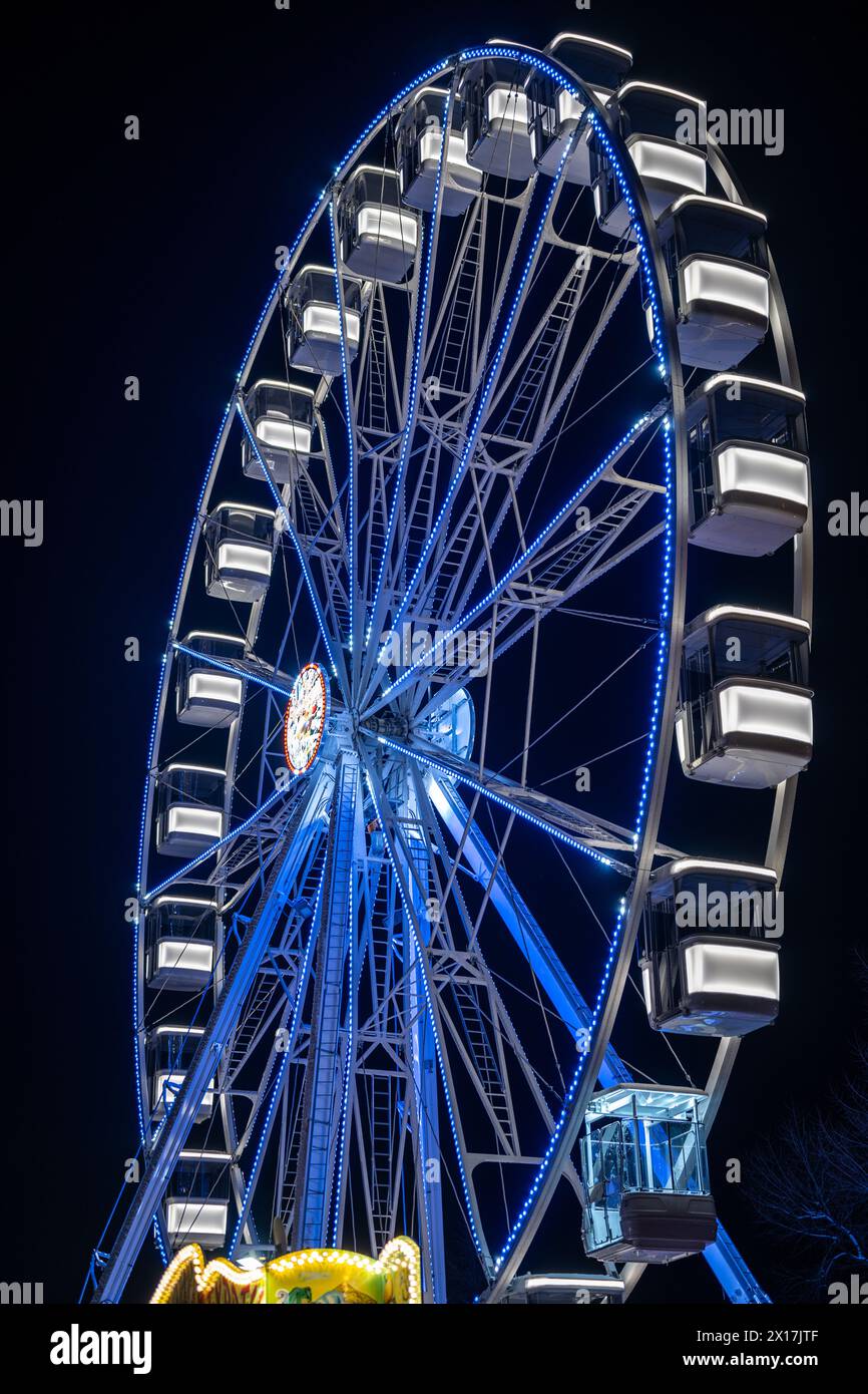 Description: Ferris wheel with blue lights photographed from low angle ...