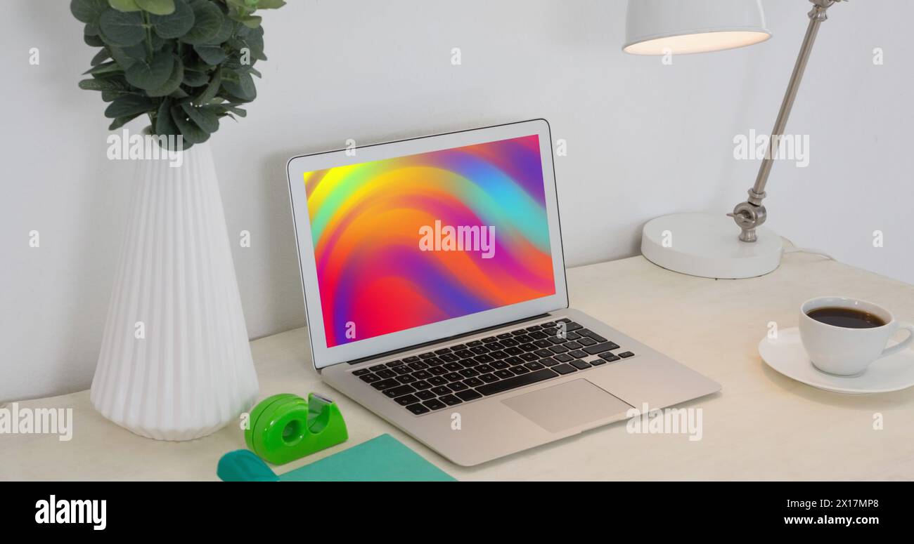 Image of laptop with colorful moving shapes on screen on desk Stock ...