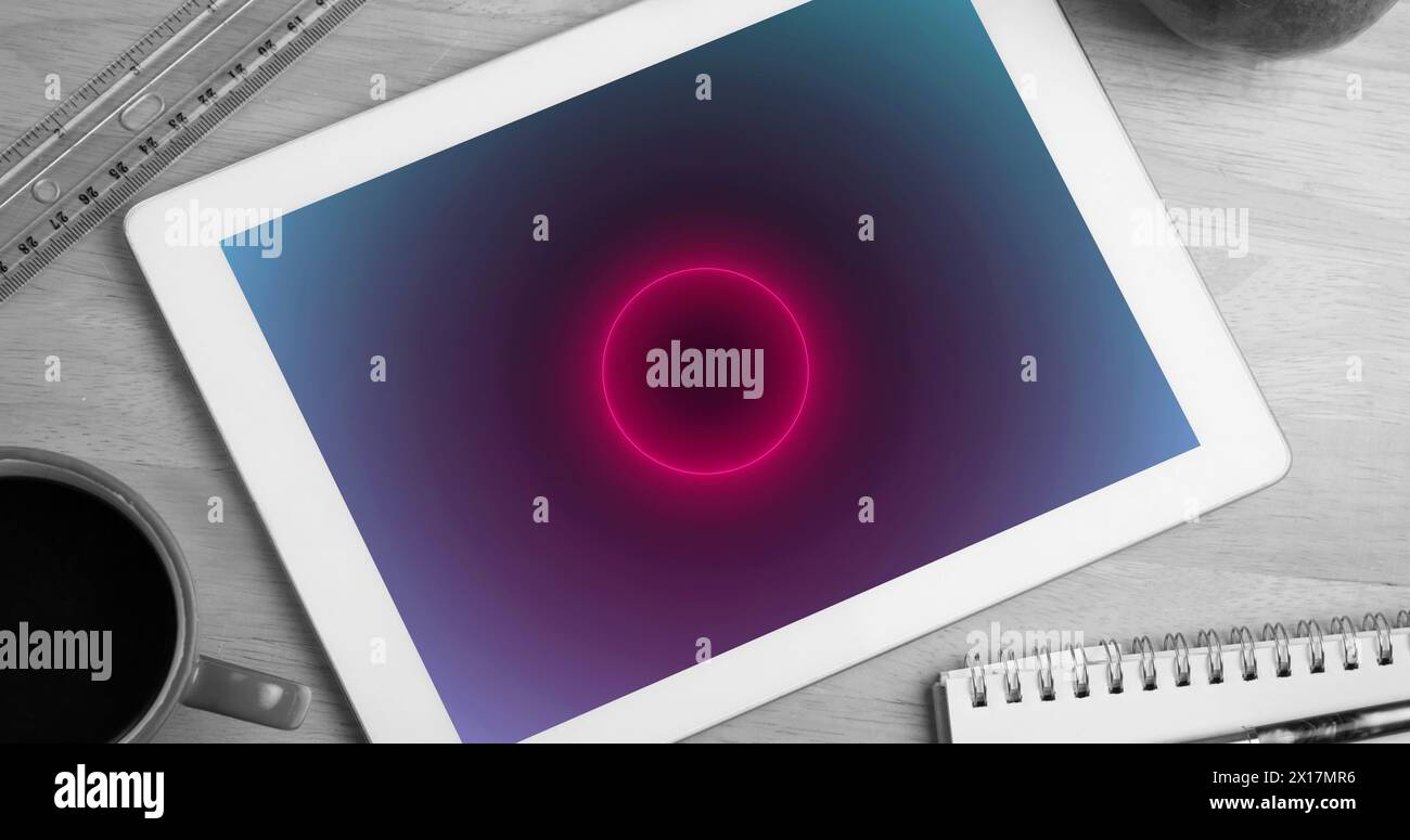 Image of tablet with neon circles moving on screen on desk Stock Photo ...