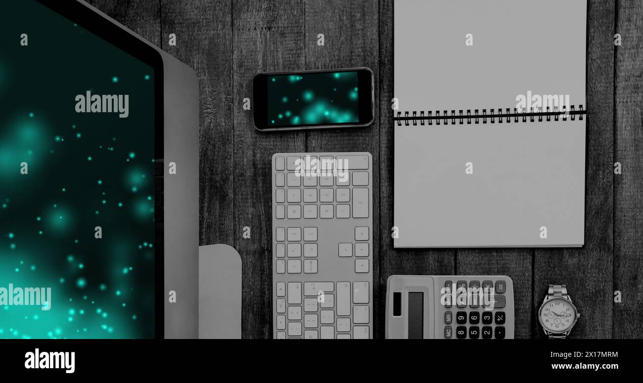 Image of technological devices with light spots on screen on desk Stock ...