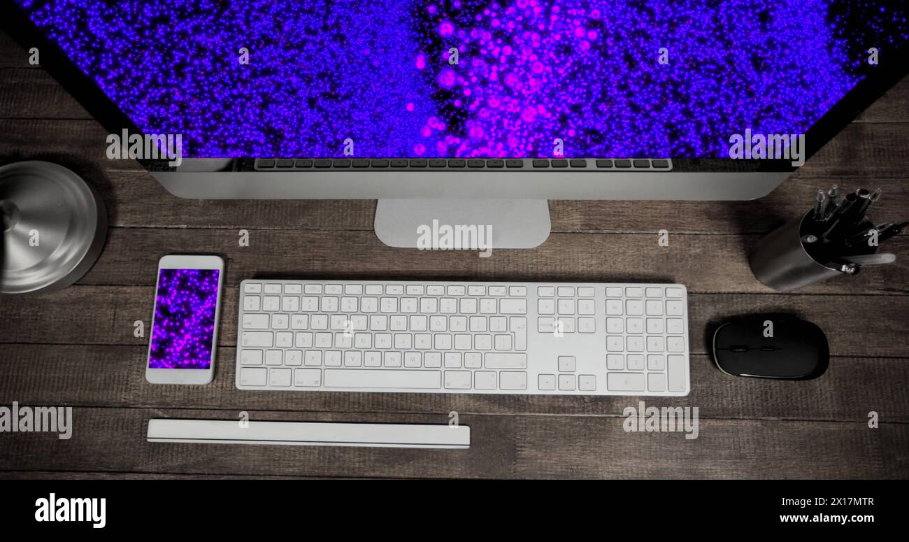 Image of technological devices with light spots on screen on desk Stock ...