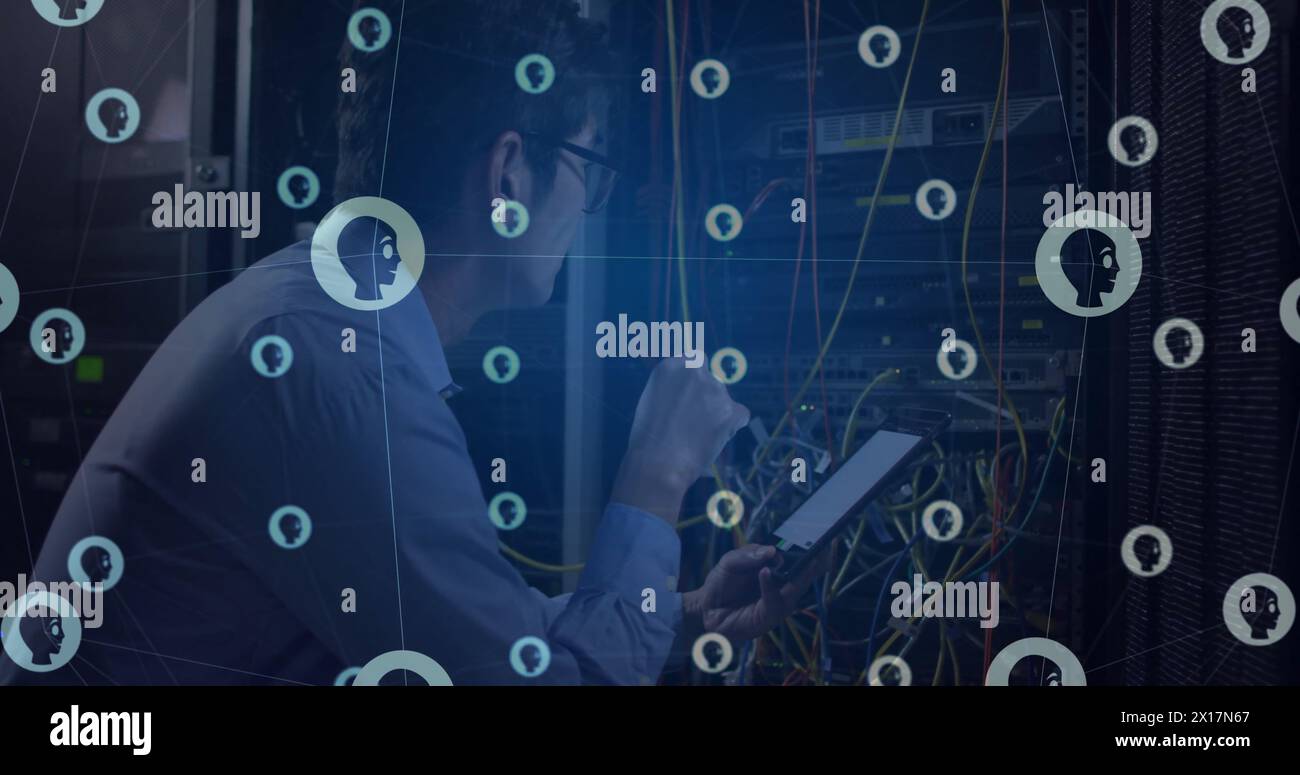 Image of grid of people icons over asian male technician working in ...