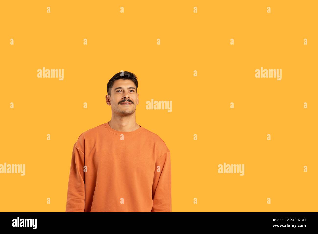 Millennial guy with moustache on orange backdrop Stock Photo - Alamy