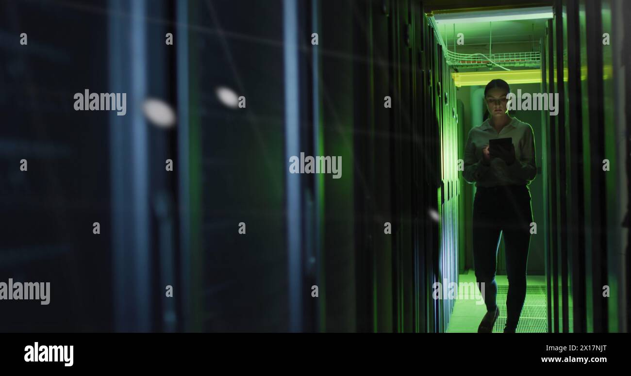 Data Processing Against Caucasian Female Engineer With Digital Tablet Working In Server Room