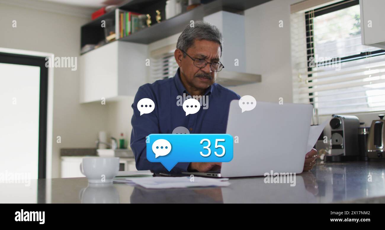 Image of emoji icons over man using laptop Stock Photo - Alamy