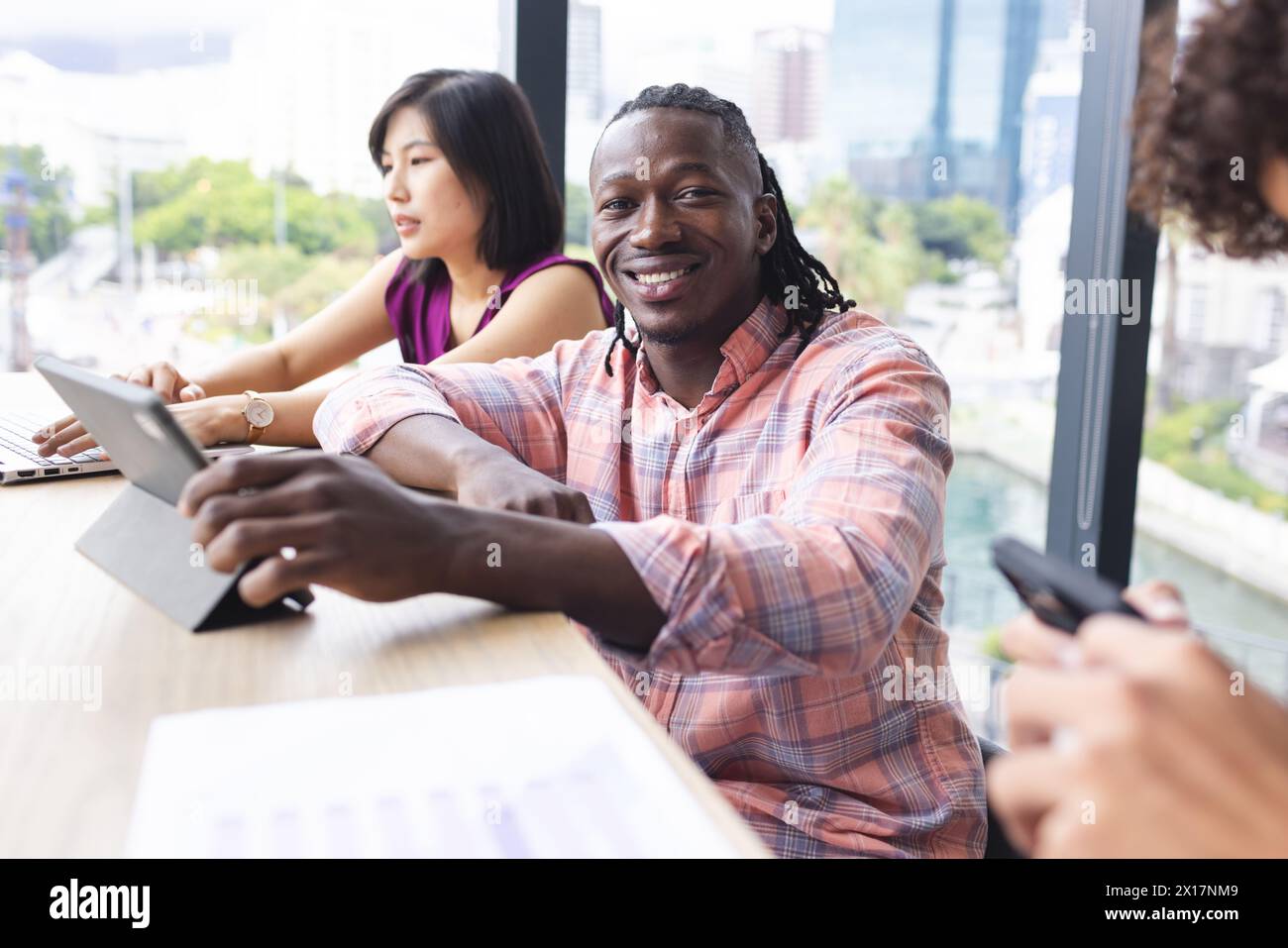 Diverse group of young adults working together in a modern business ...