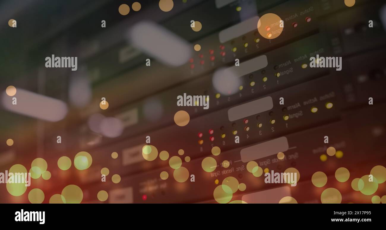 Image of computer language and falling lens flares over multiple modems ...