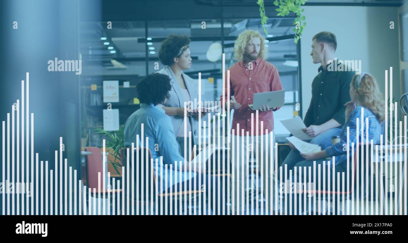 Image of bar graph moving over multiracial businessman with laptop ...