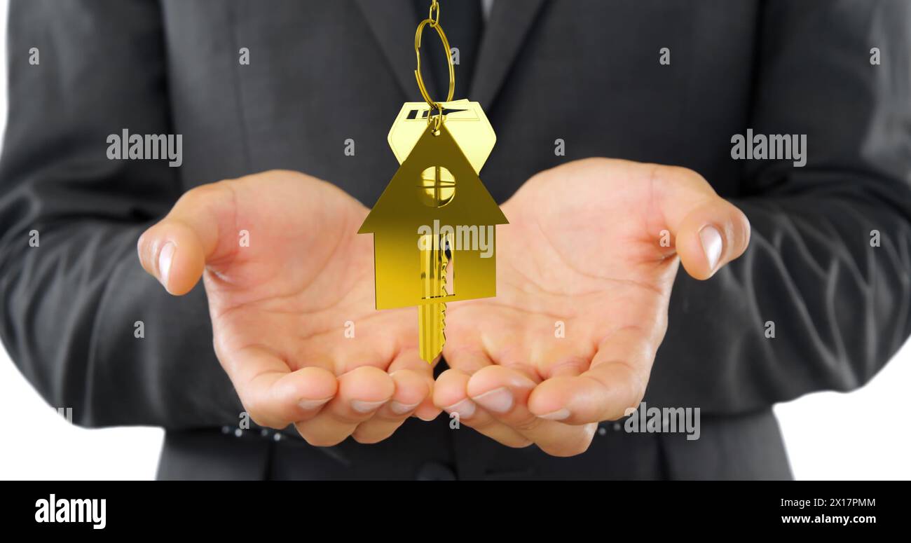 Image of golden house keys and house shaped key fob spinning over ...