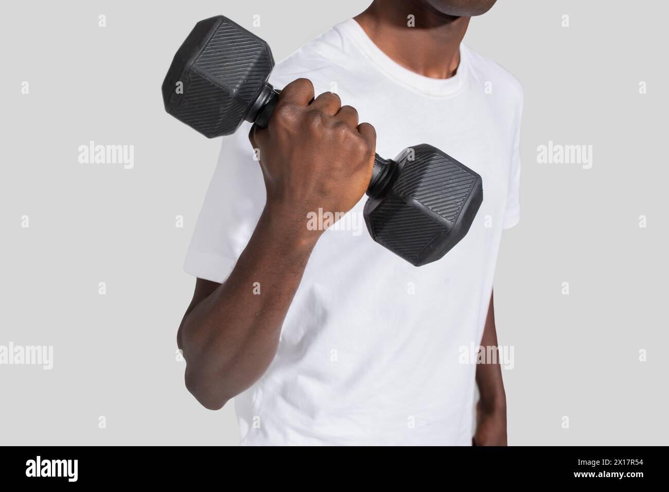Man lifting a dumbbell showing strength on white background Stock Photo ...