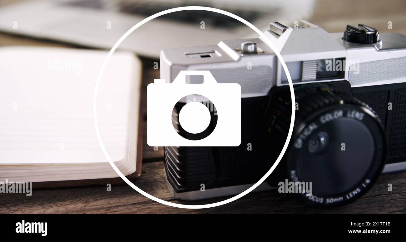 Image of camera icon over camera on desk Stock Photo - Alamy