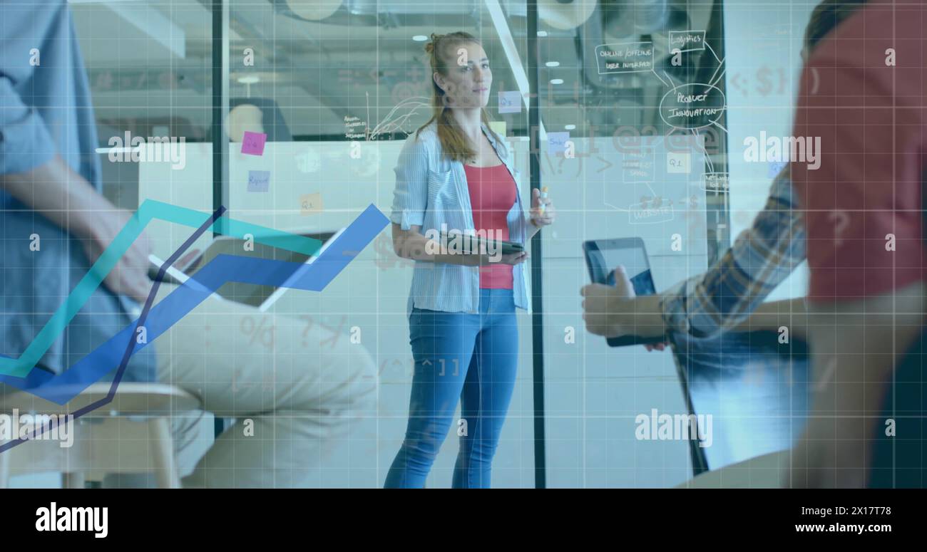 Image of blue line and data processing over diverse business people in ...