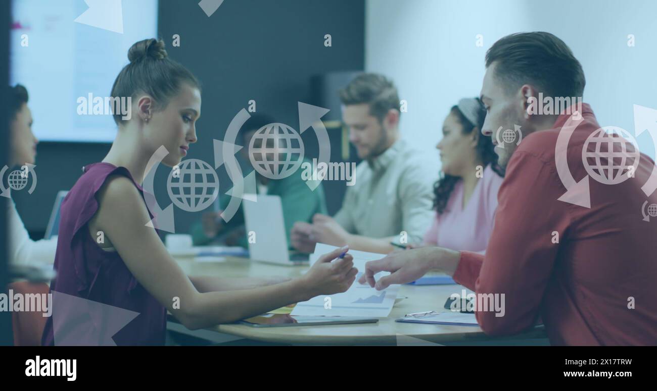 Image of globe with arrows icons over diverse business people at ...
