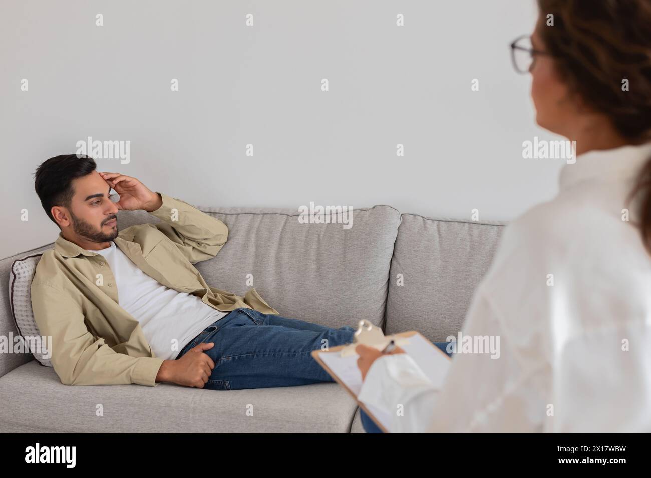 Man in therapy session with lady therapist Stock Photo - Alamy