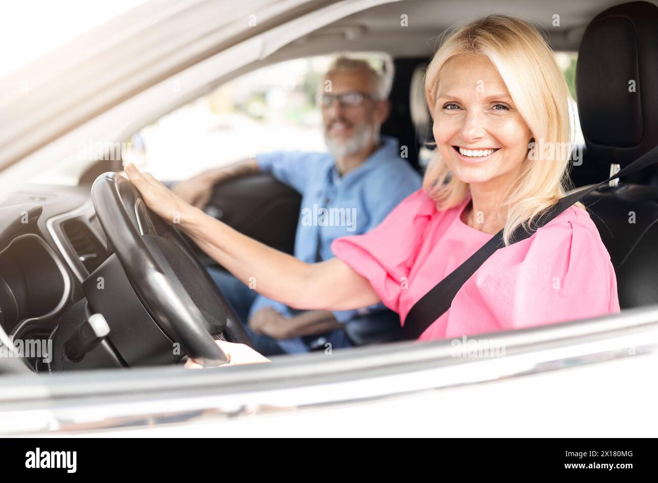 Elderly woman happily driving with husband, traveling together Stock ...