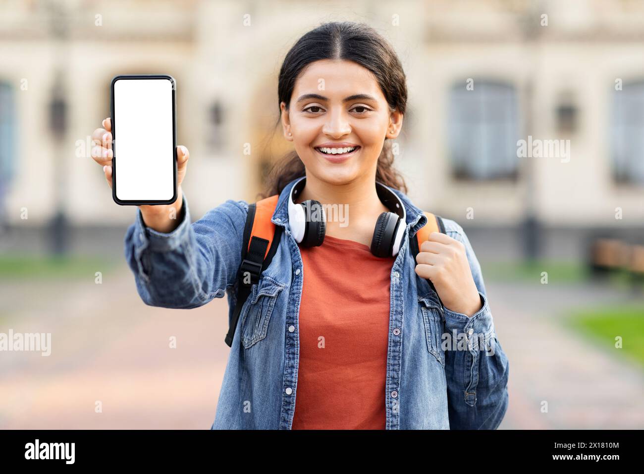 Smiling Indian woman student showing smartphone camera Stock Photo - Alamy