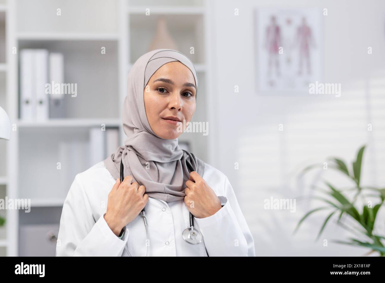 A portrait of a resilient and confident Muslim female doctor wearing ...