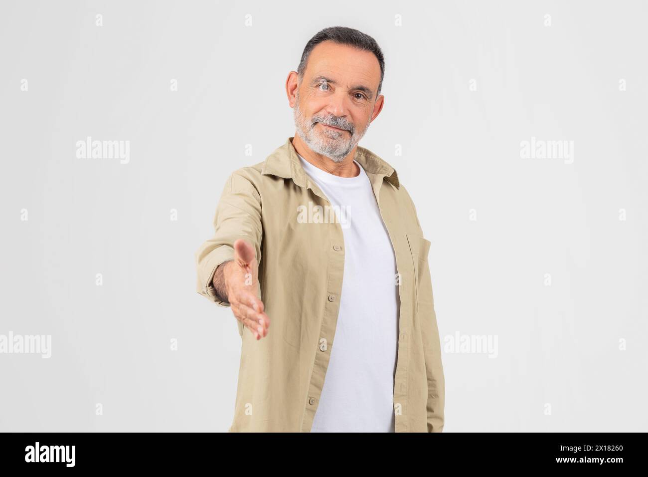 Senior man reaching out for a handshake Stock Photo - Alamy