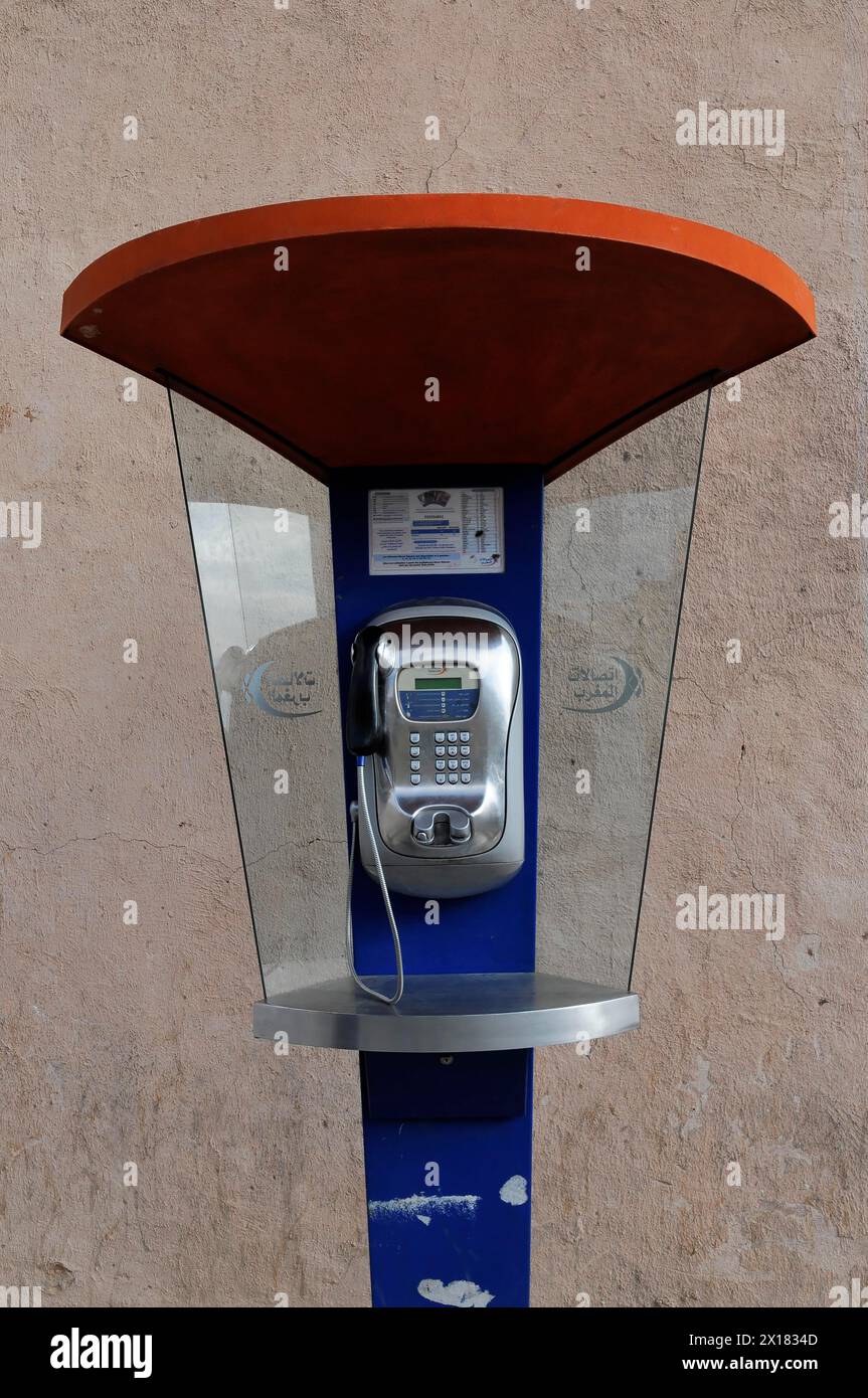 Meknes, Public telephone box in orange and blue with modern ...