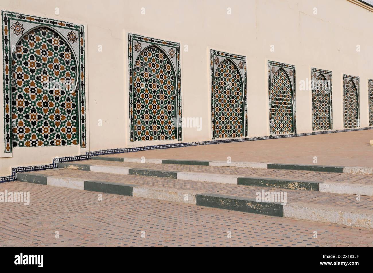 Meknes, wall with colourful mosaic tiles and window openings over ...