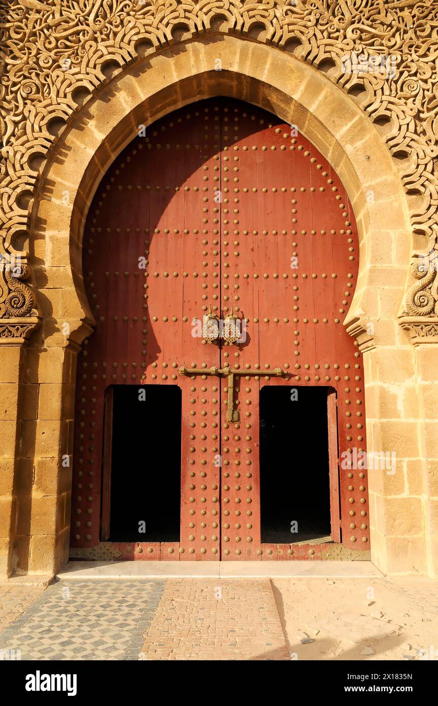 Meknes, Old red gates in Moroccan style with ornate carvings on a stone ...
