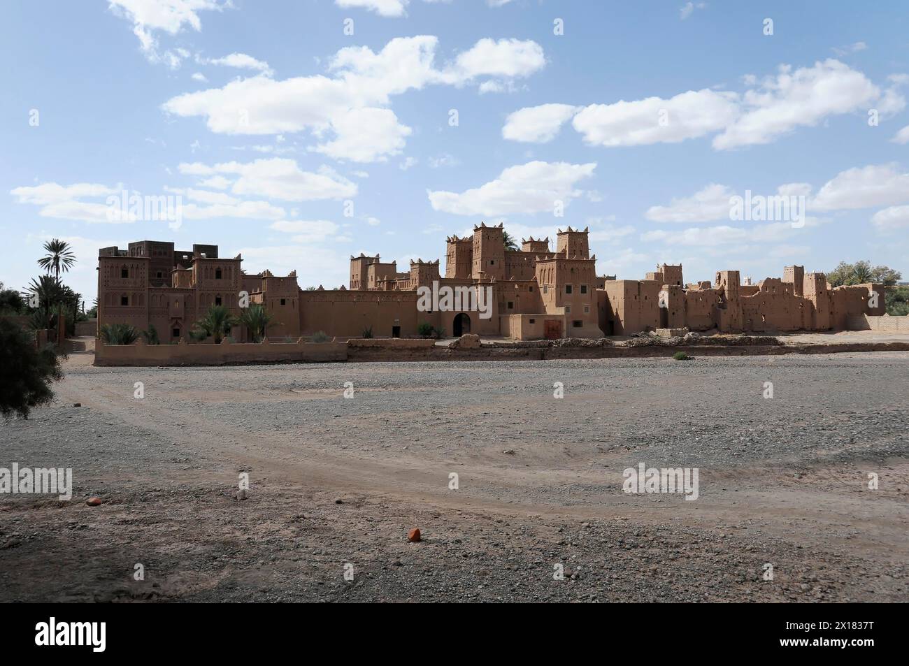 Ait Benhaddou, Historic adobe fortress in a desert landscape with palm ...