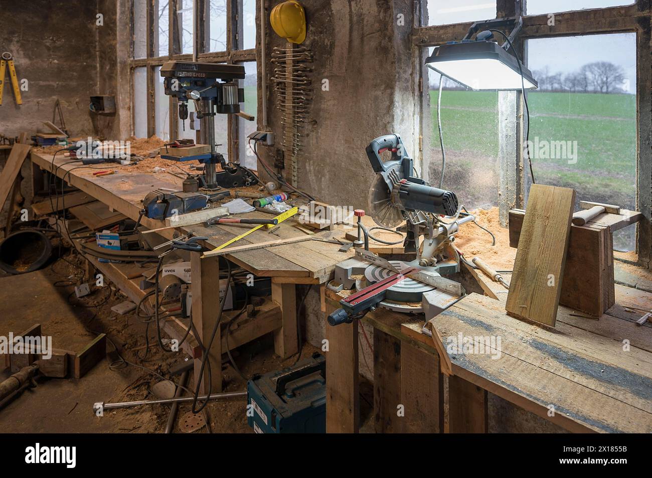 Workbench with drill stand and circular saw in a workshop, Mecklenburg ...